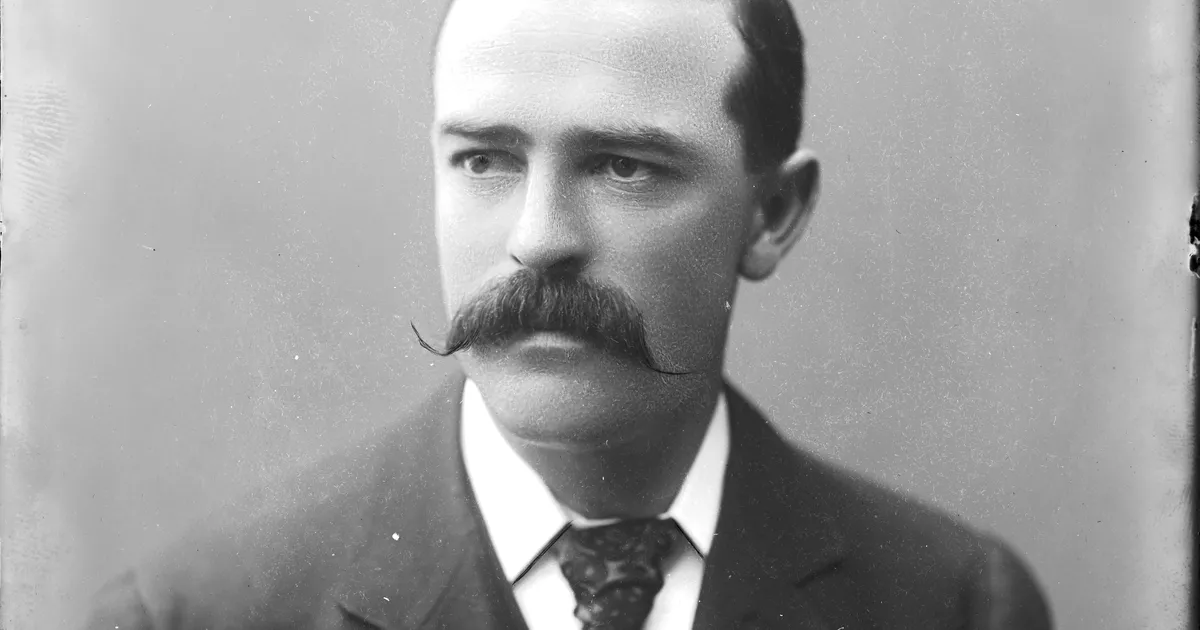 Studio portrait of a gentleman with manicured moustache and patterned ...