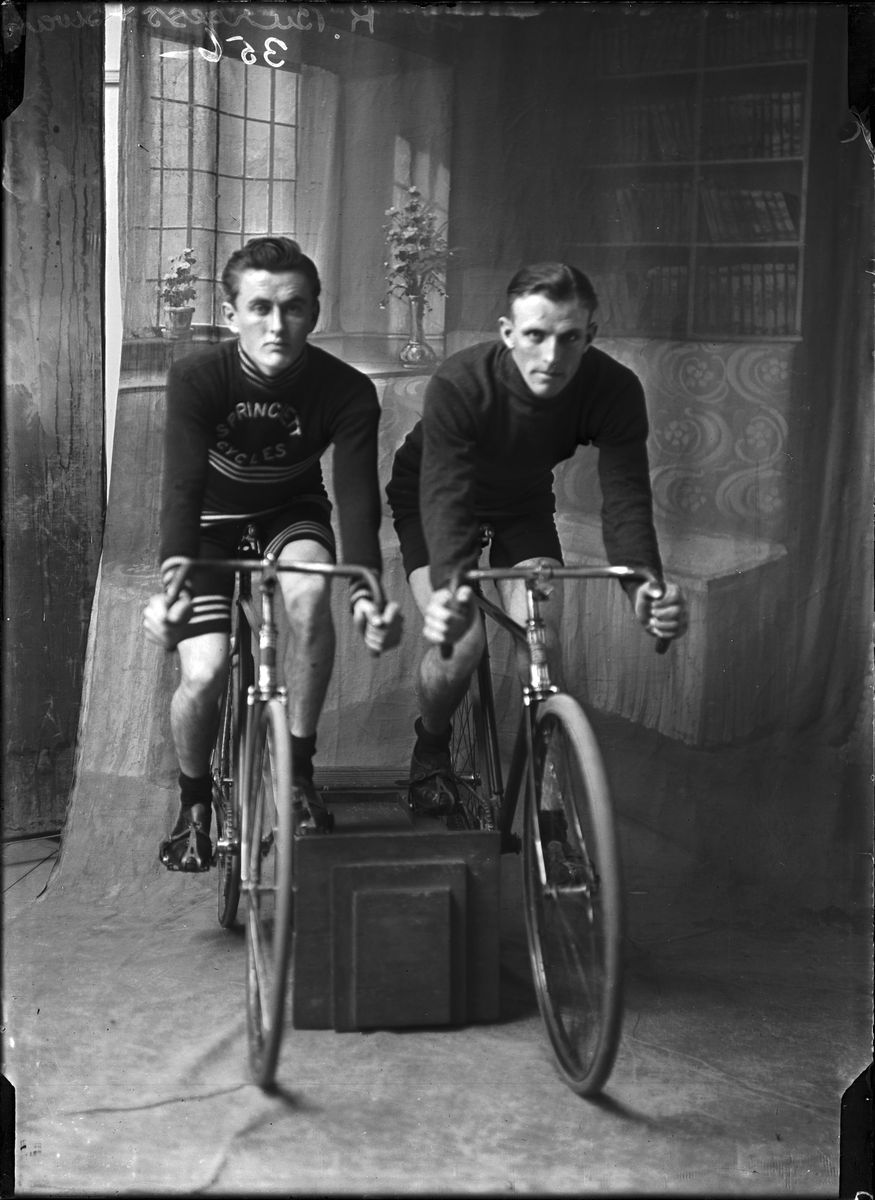 Studio portrait of two young men on bicycles - AGSA Collection
