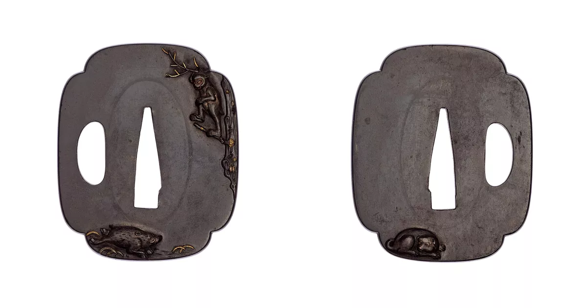 Tsuba, obverse: a wild boar running in grass beneath a tree. A monkey ...