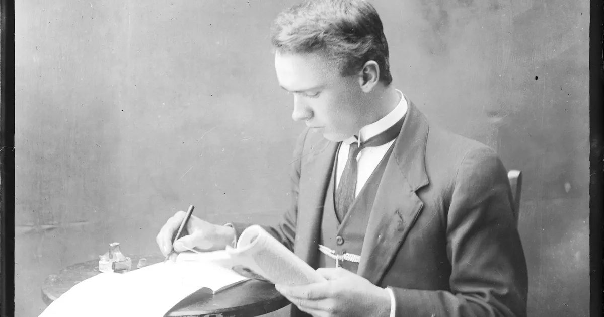 Portrait of young man in front of open book - AGSA Collection