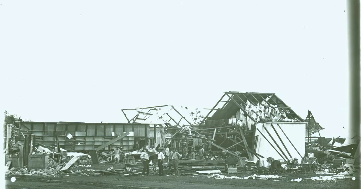 Men salvaging items after cyclone destroyed buildings - AGSA Collection