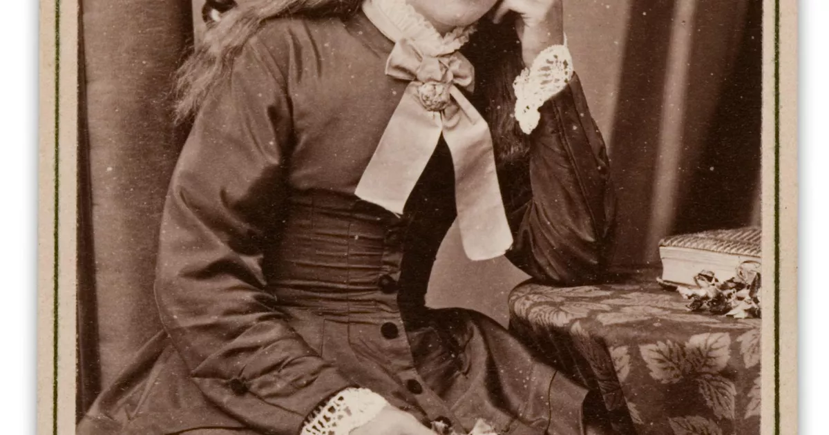Portrait of young woman, hand held to cheek, bow at neck - AGSA Collection