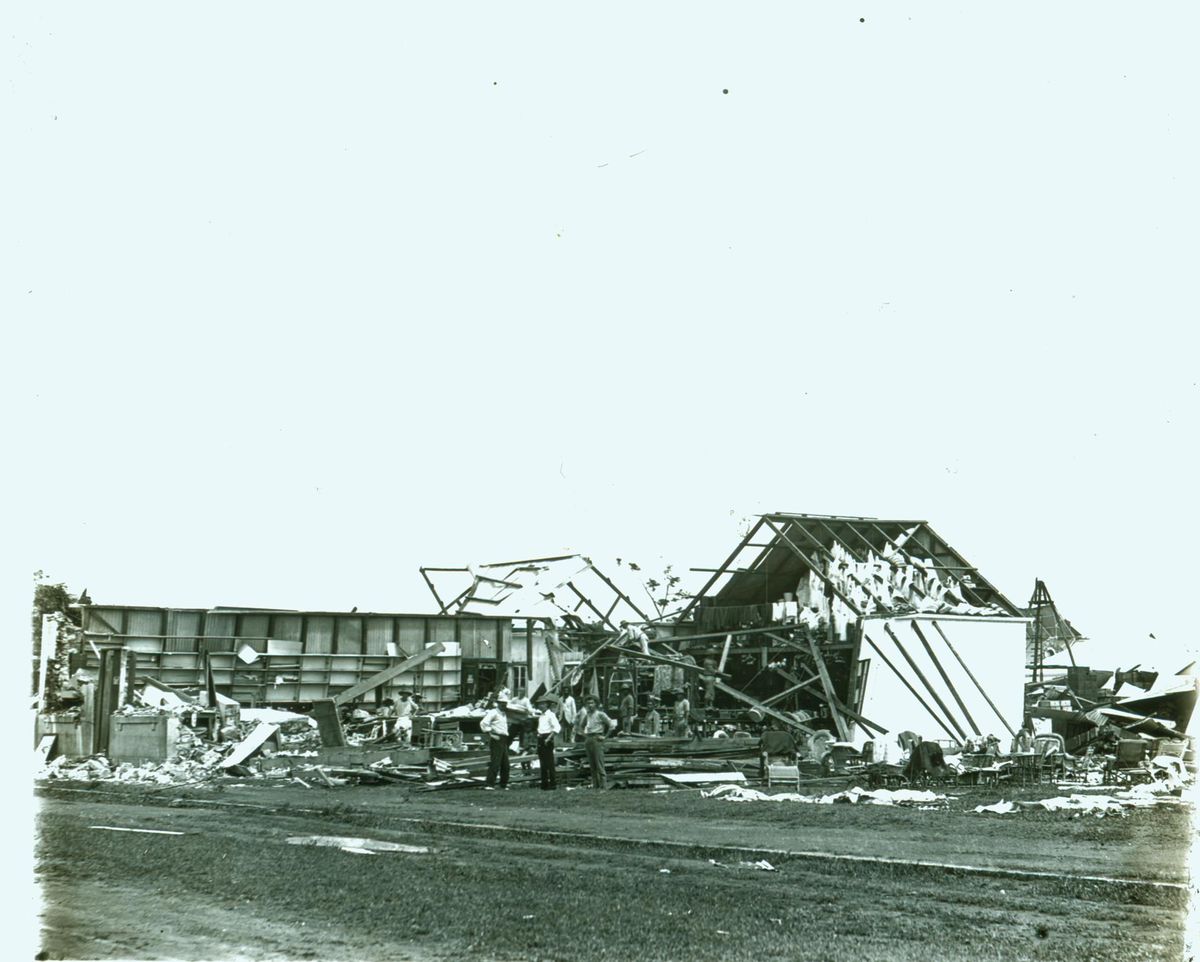 Men salvaging items after cyclone destroyed buildings - AGSA Collection