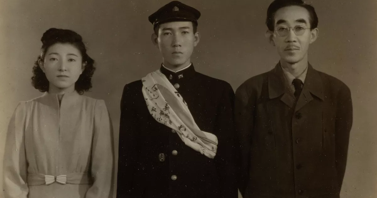 Young man wearing sash with parents - AGSA Collection